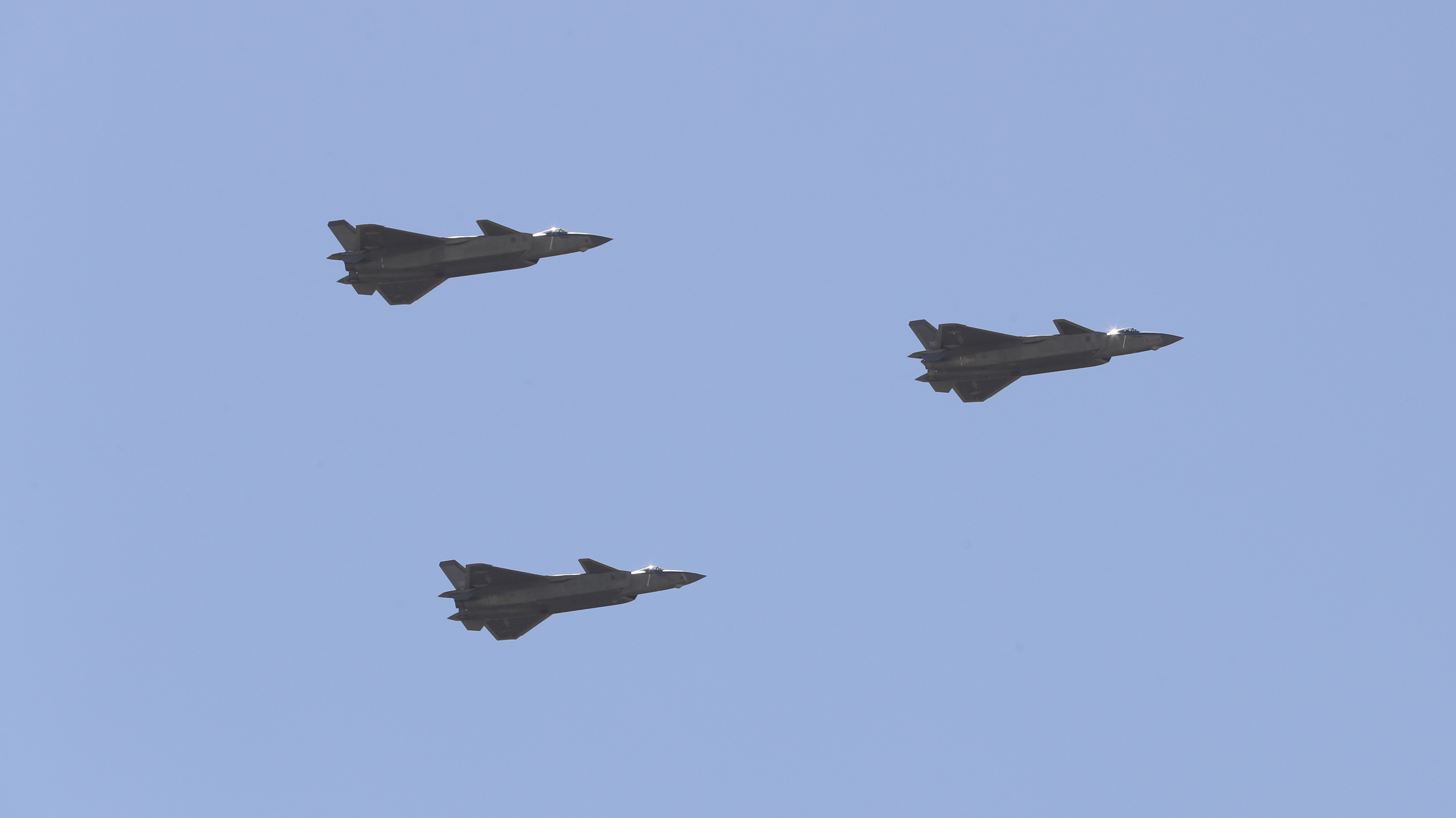 Chinese J-20 stealth fighter jets fly past during a military parade at ...