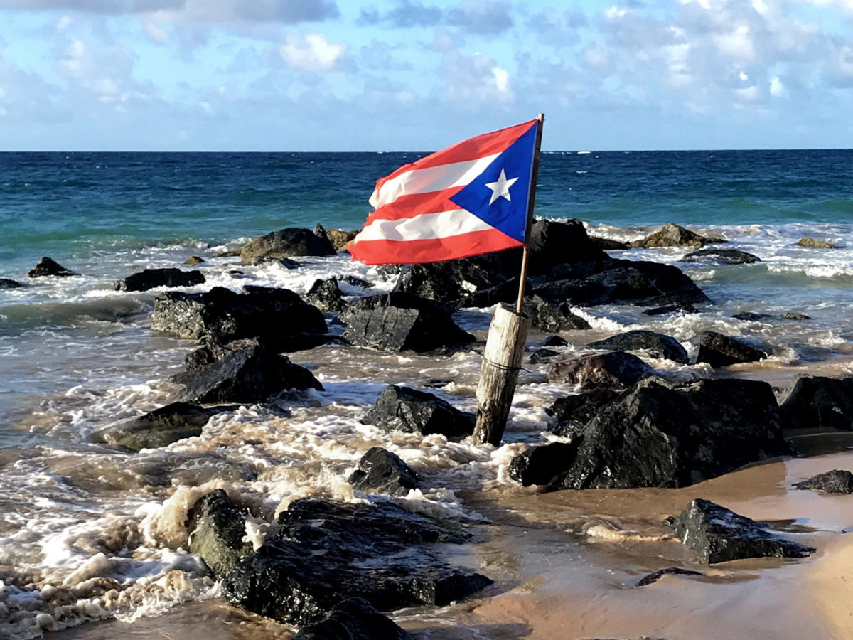 The Puerto Rico flag flies on the beach in Condado, a neighborhood of ...